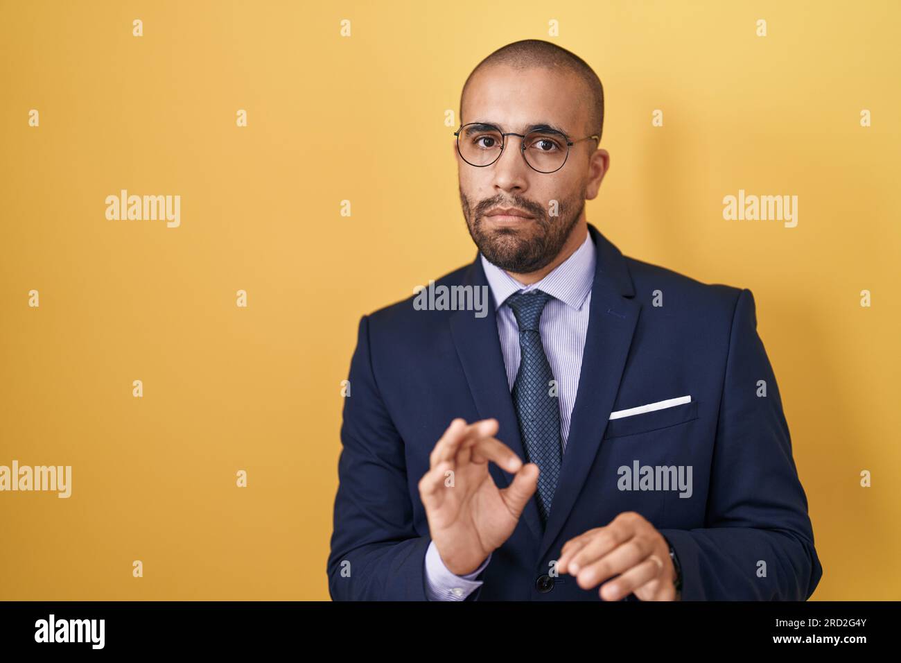 Hispanic man with beard wearing suit and tie disgusted expression ...