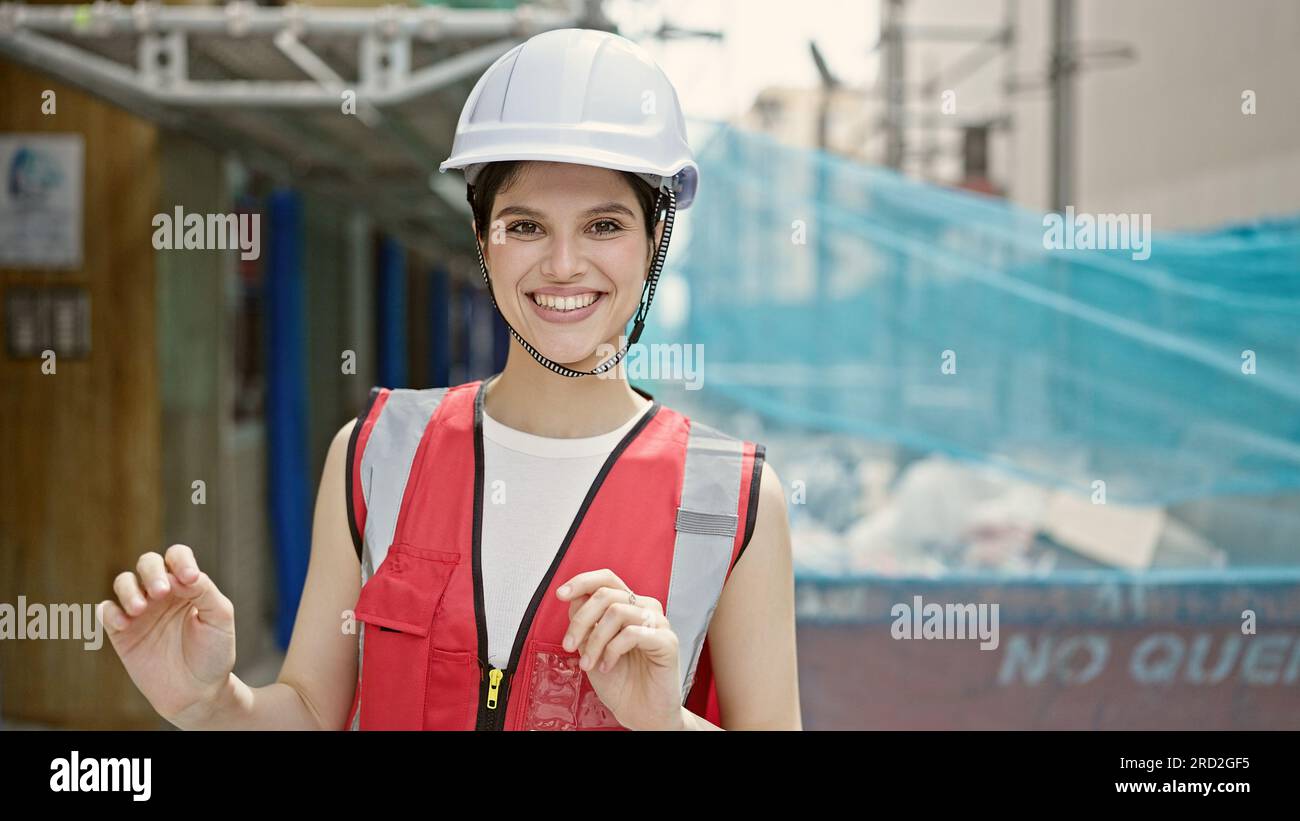 Young beautiful hispanic woman builder smiling confident standing at ...