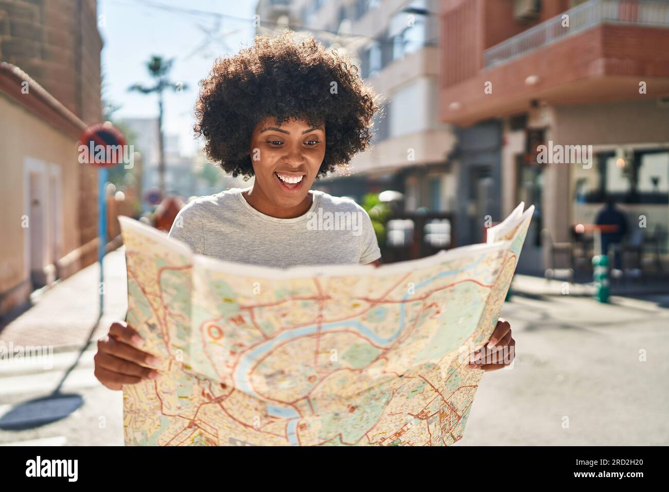 African american woman smiling confident holding city map at street ...