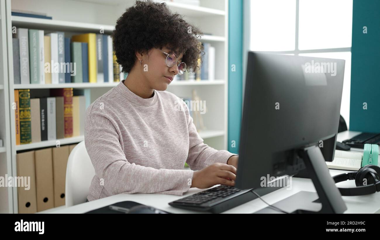 Young african american woman student using computer studying at ...