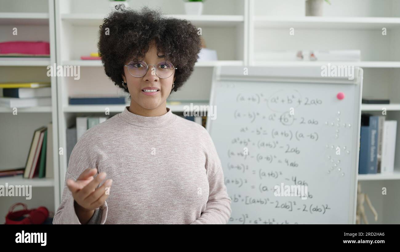 Young african american woman teacher teaching maths lesson at ...