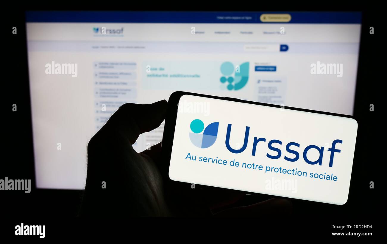 Person holding cellphone with logo of French social security ...