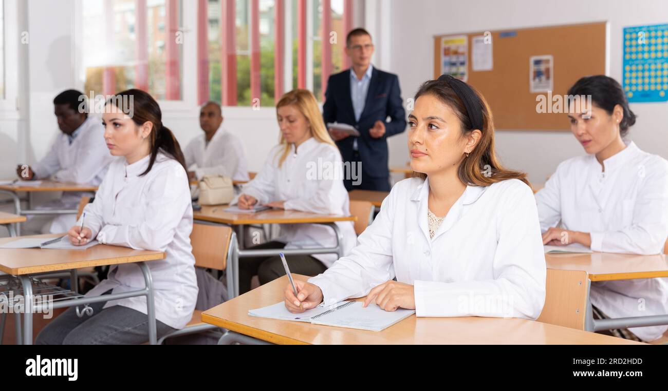 Medical students writing in notepads lesson Stock Photo - Alamy