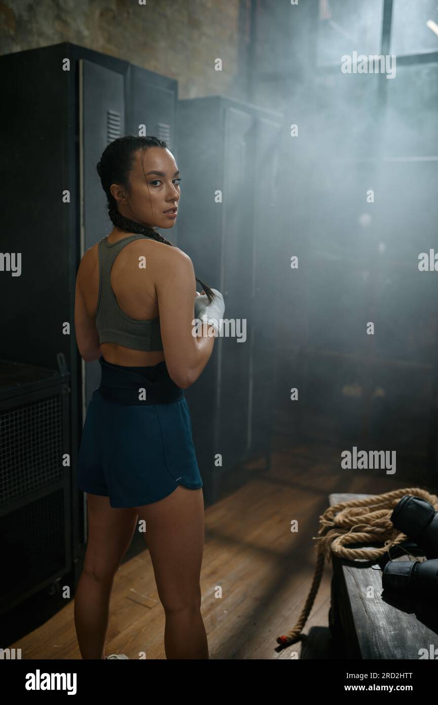 Healthy strong female boxer portrait over old vintage locker room at ...