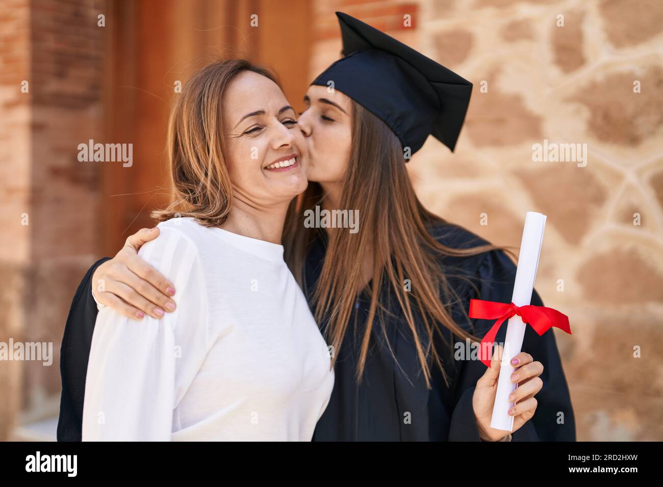Two Women Mother And Graduated Daughter Standing Together At Campus
