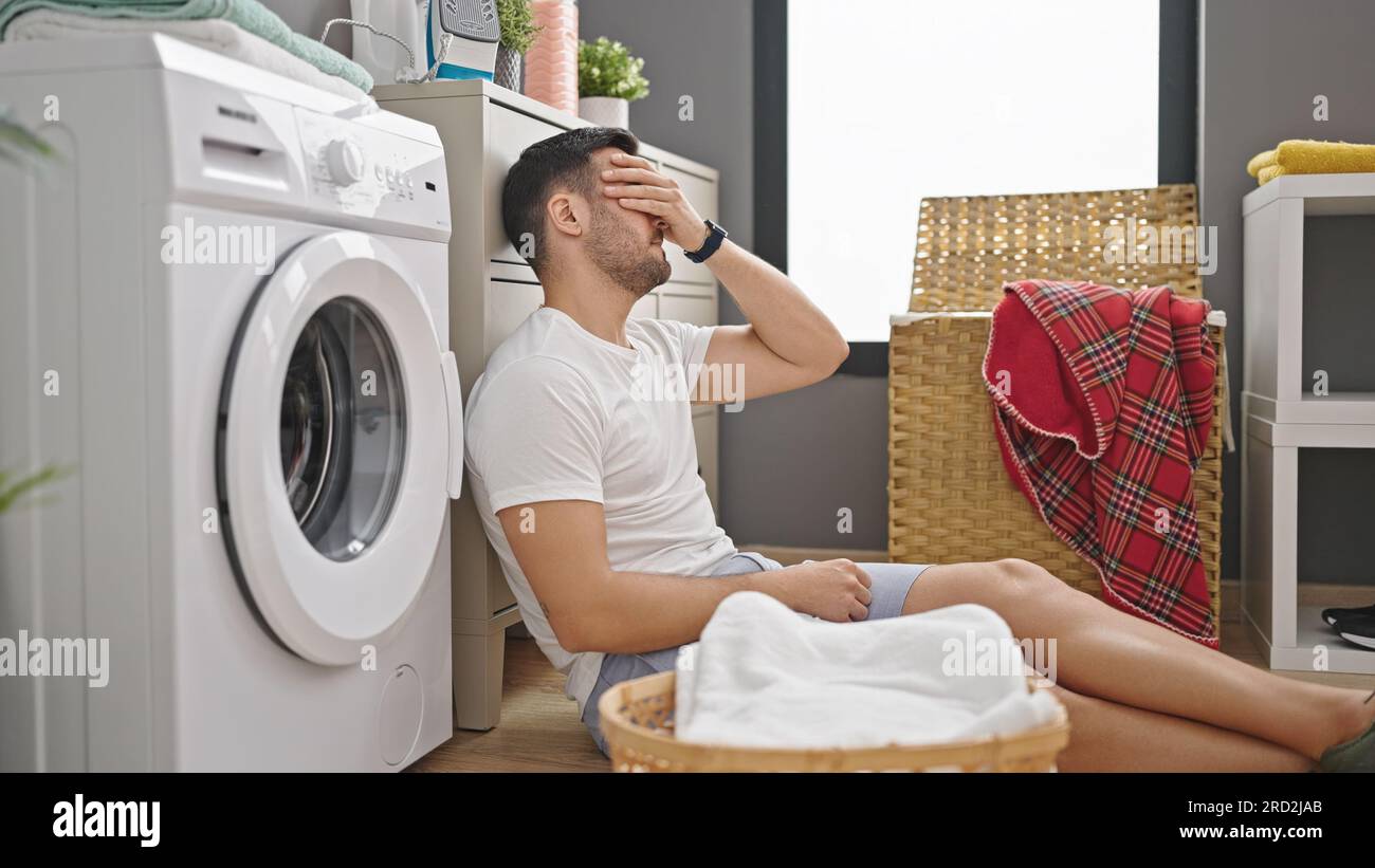 Tired man waiting washing machine hi-res stock photography and images ...
