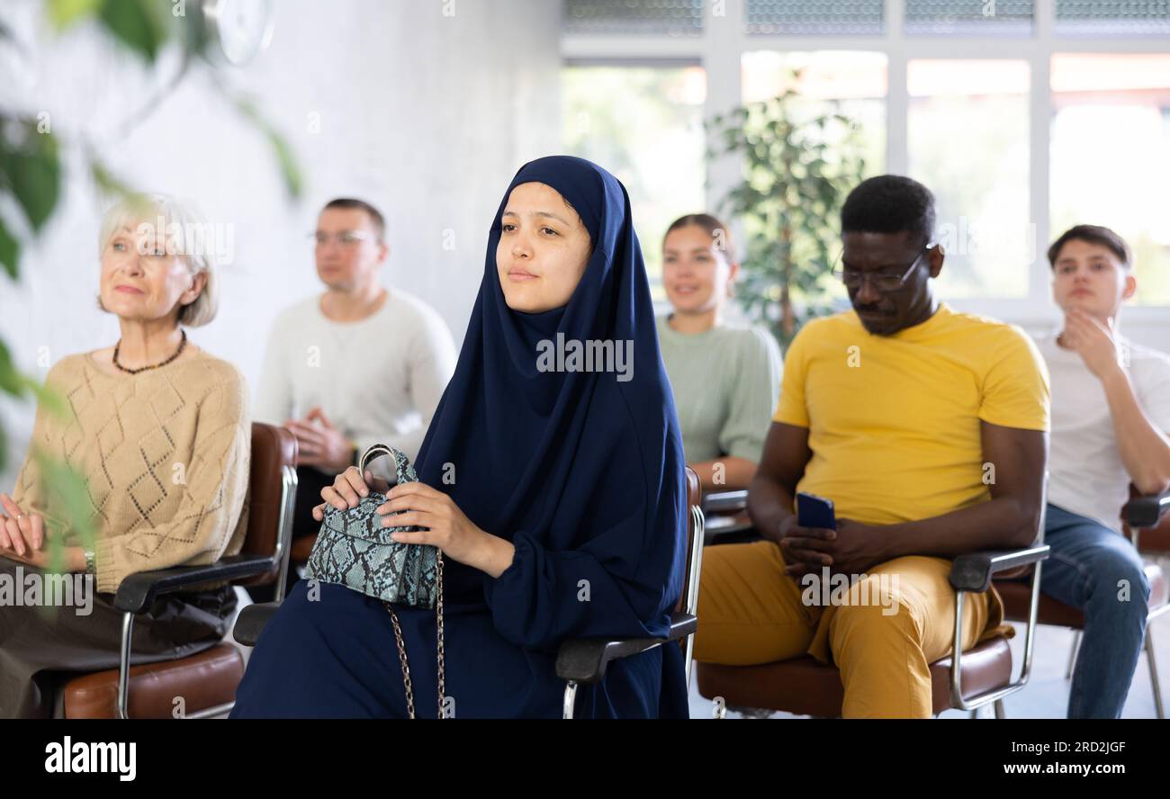 Young asian girl sitting in lecture hall with group Stock Photo - Alamy