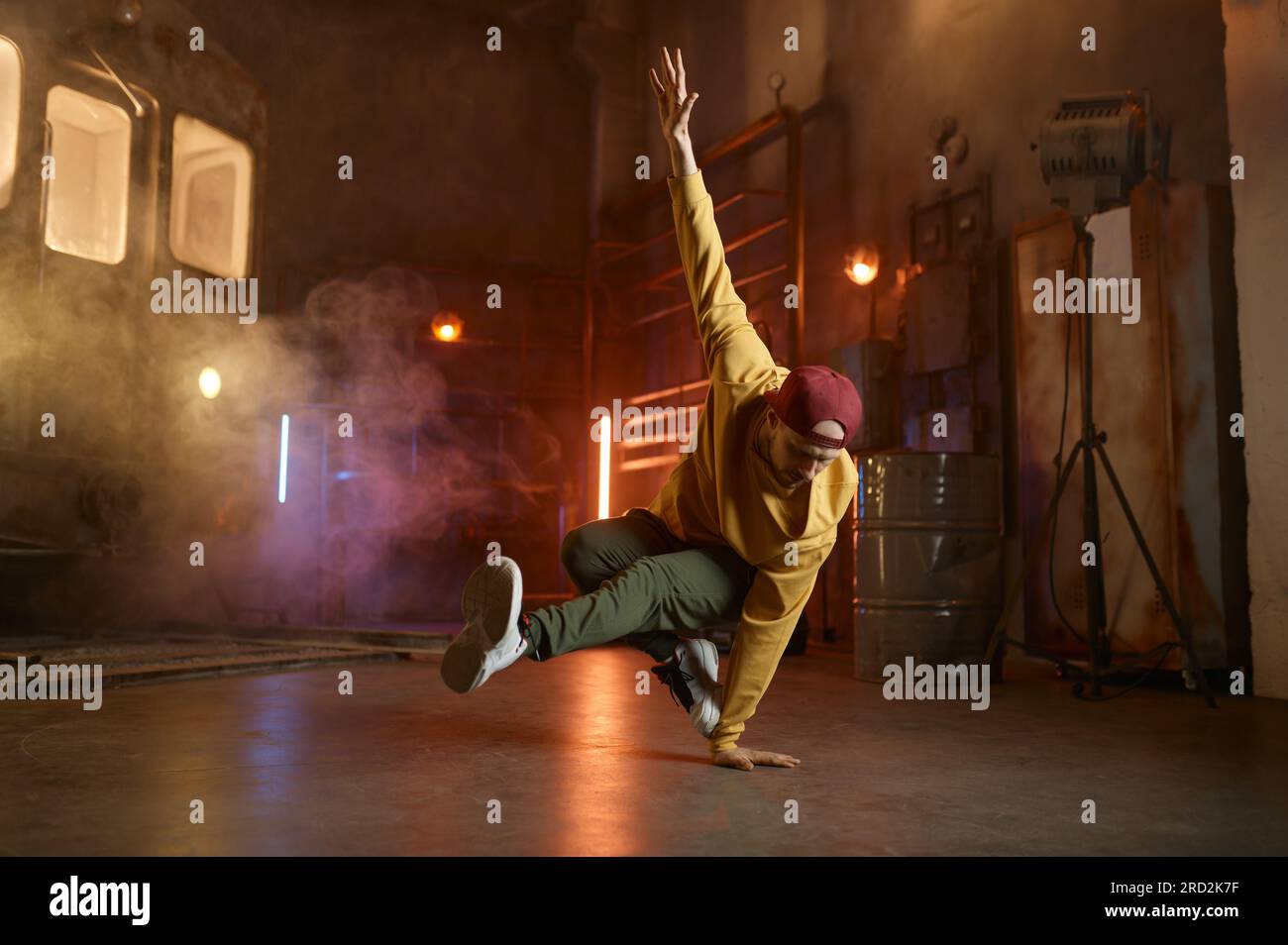 Handsome young man dancing movements over urban studio background Stock ...