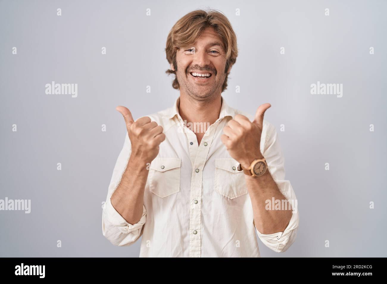 Middle age man standing over isolated background success sign doing ...