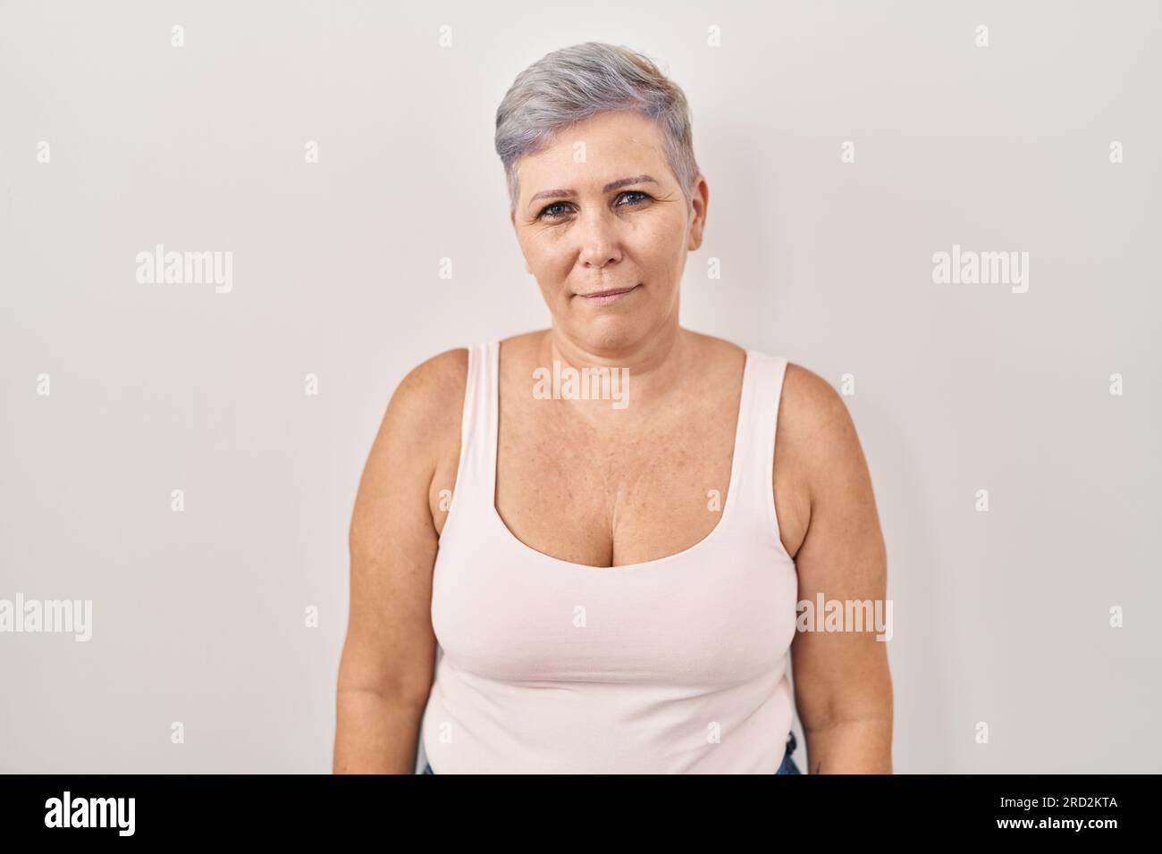 Middle age caucasian woman standing over white background depressed and ...