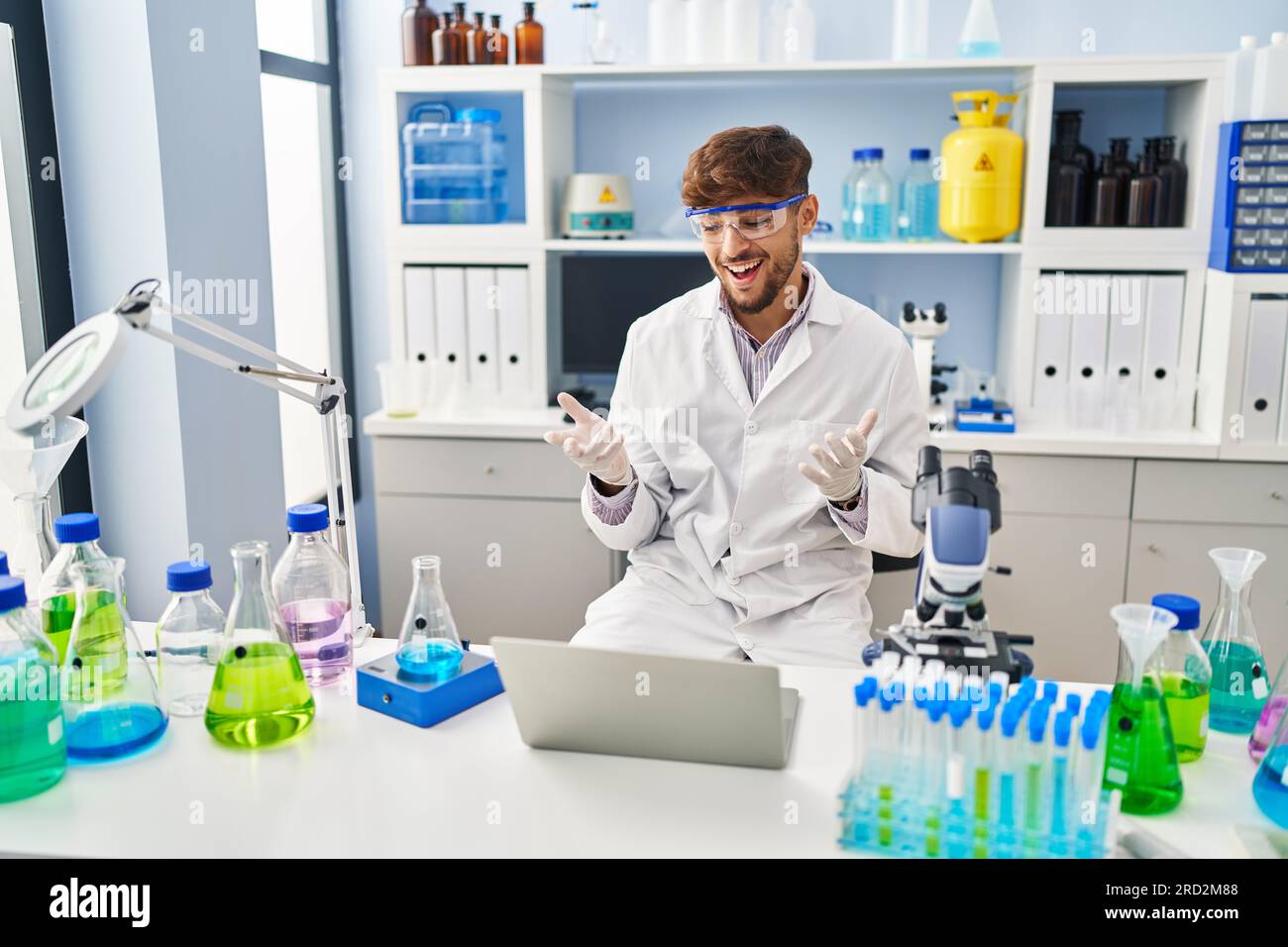 Young arab man scientist having video call working at laboratory Stock ...
