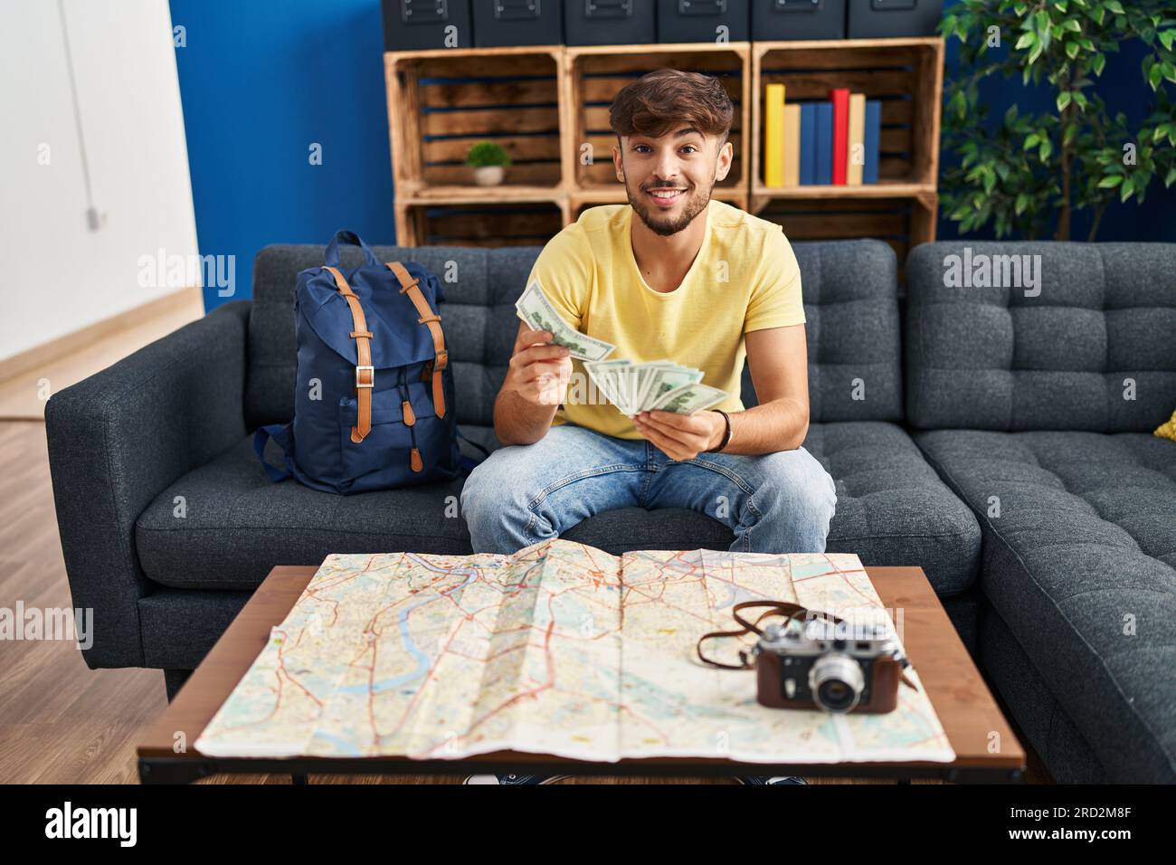 Young arab man smiling confident counting dollars at home Stock Photo ...