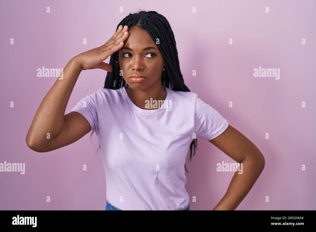 African american woman with braids standing over pink background ...