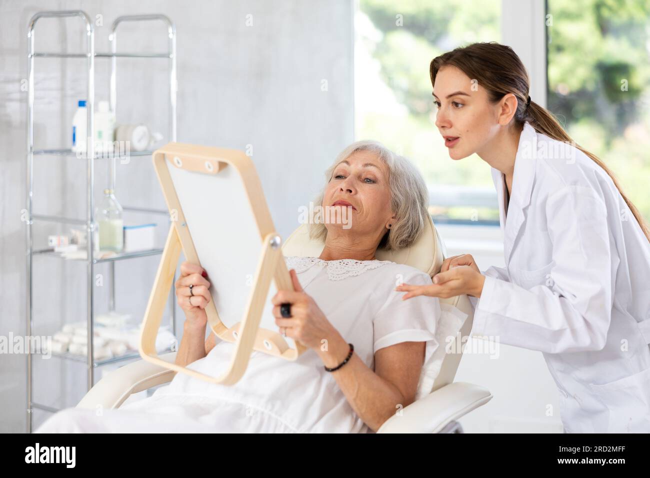 Mature patient with mirror Stock Photo - Alamy