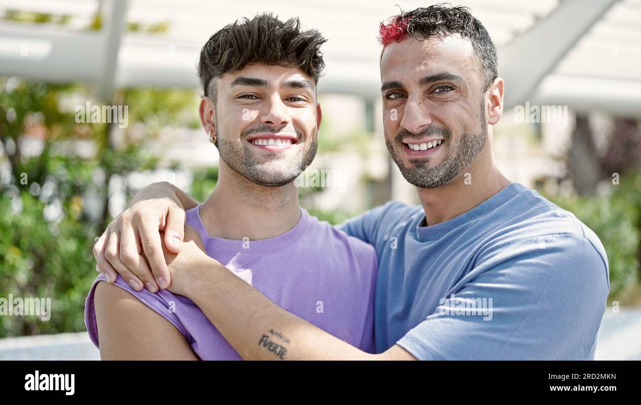 Two men couple smiling confident hugging each other at park Stock Photo ...