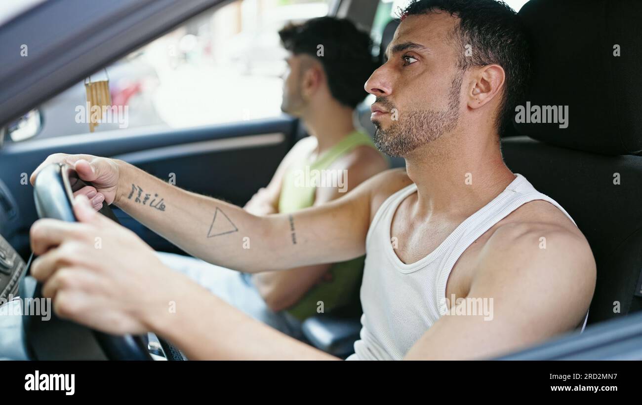 Two men couple driving car at street Stock Photo - Alamy