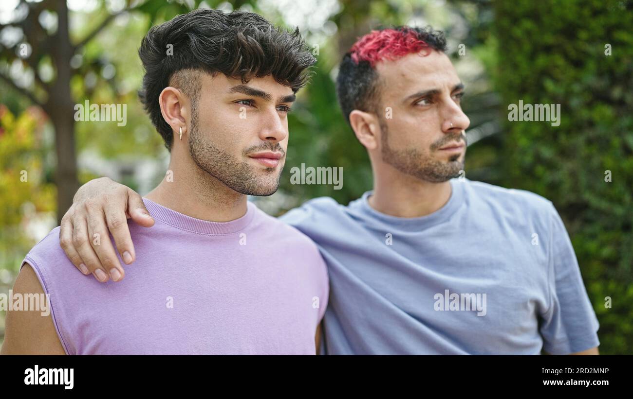 Two men couple hugging each other with relaxed expression at park Stock ...