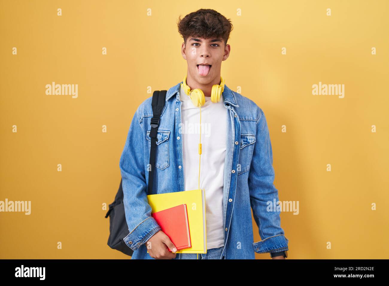Hispanic teenager wearing student backpack and holding books sticking ...