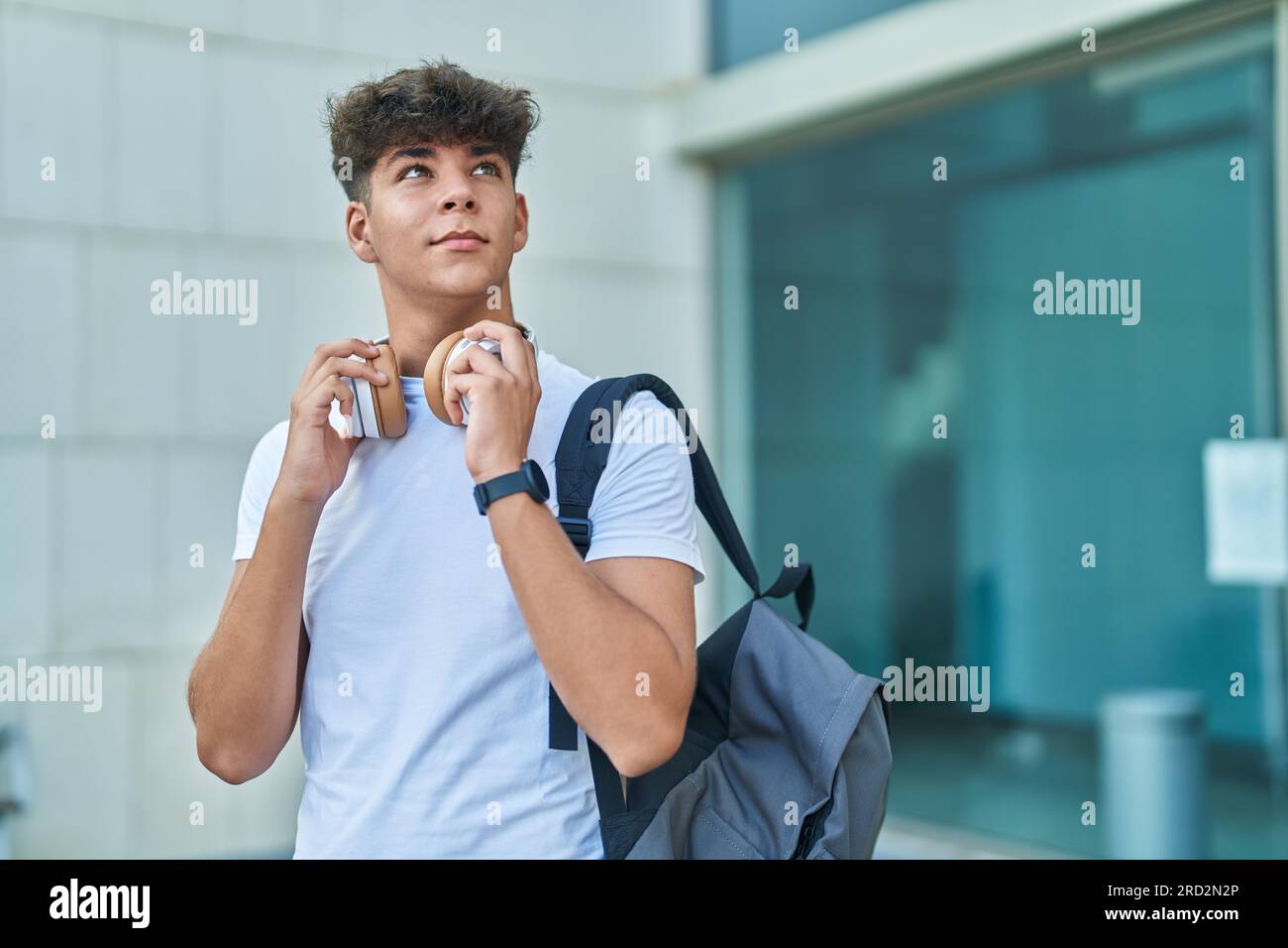 Young hispanic teenager student smiling confident wearing backpack at ...