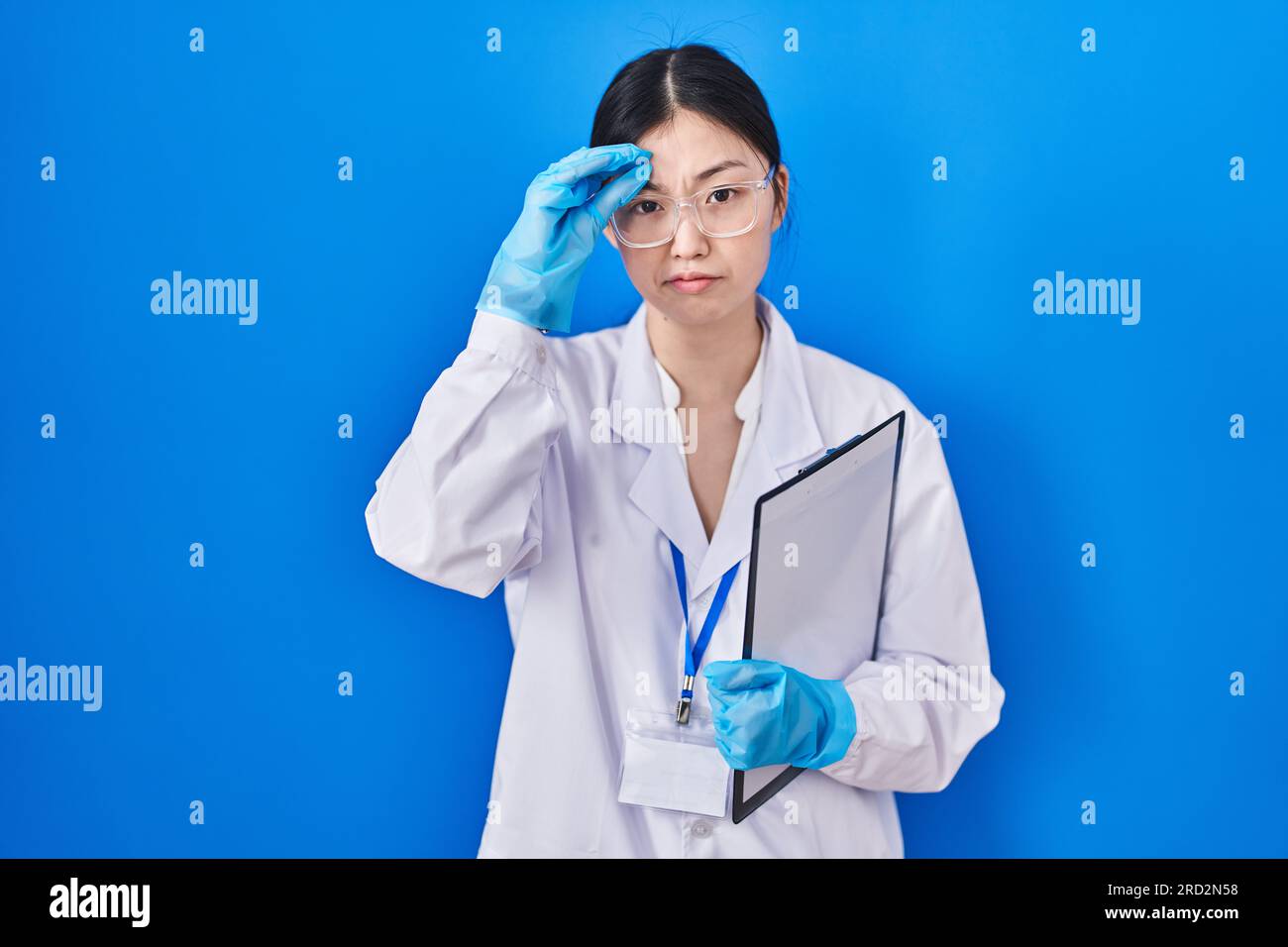 Chinese young woman working at scientist laboratory worried and ...