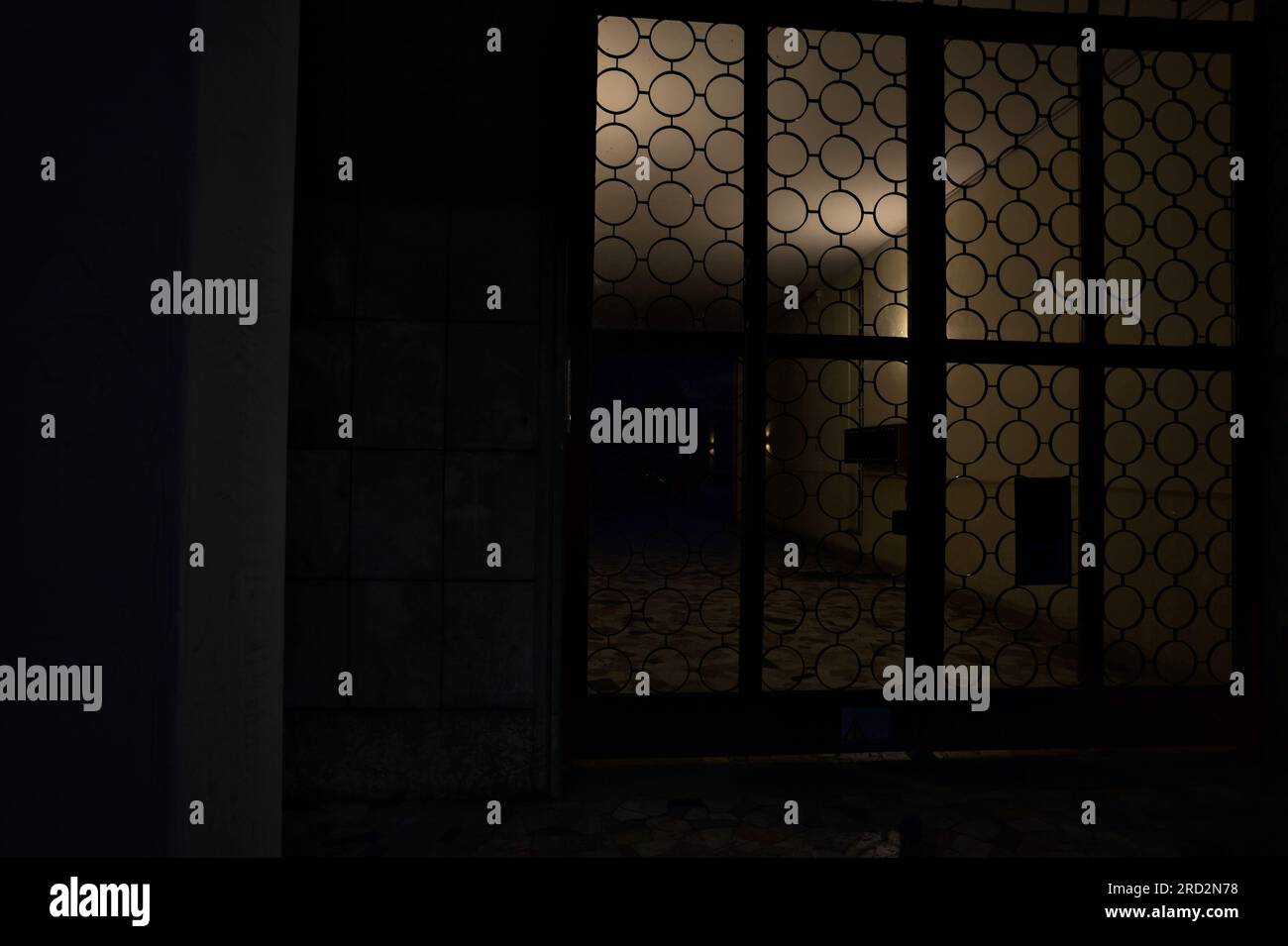 Gate at the entrance of a building at night Stock Photo - Alamy