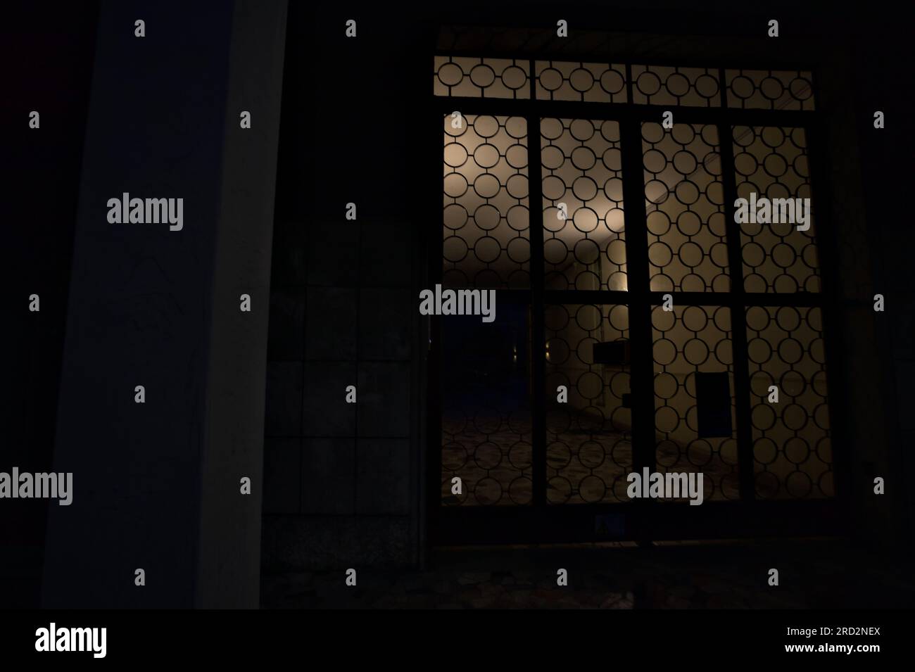 Gate at the entrance of a building at night Stock Photo - Alamy