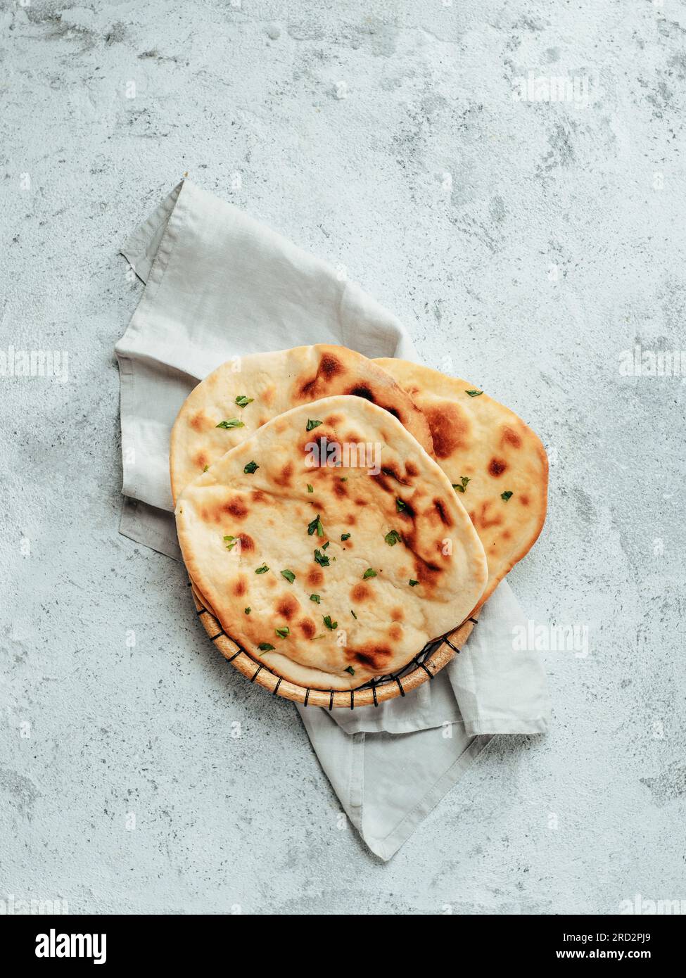 Fresh naan bread on gray cement background with copy space. Top view of ...