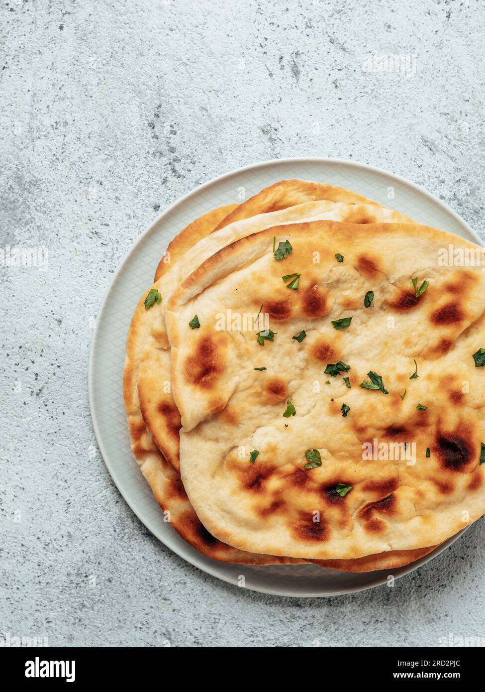 Fresh naan bread on gray cement background with copy space. Top view of ...