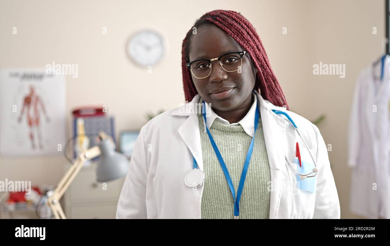 African woman with braided hair doctor smiling confident standing at ...