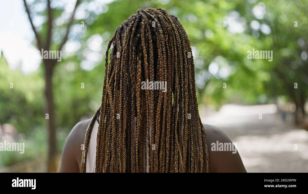 African american woman standing backwards at park Stock Photo - Alamy