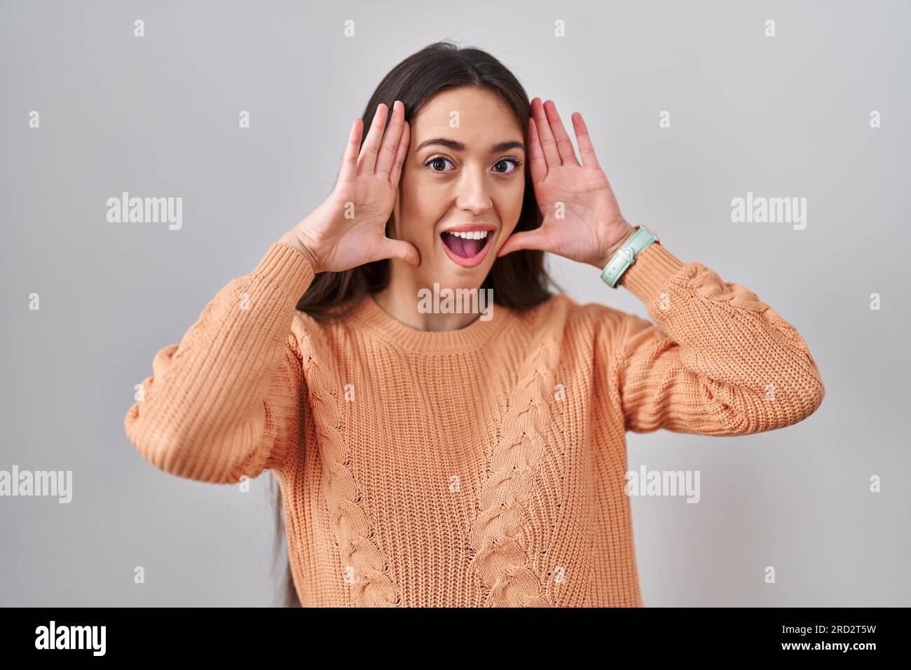 Young brunette woman standing over white background smiling cheerful ...