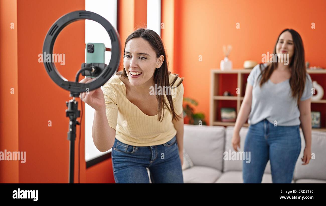 Two women recording video at home Stock Photo - Alamy