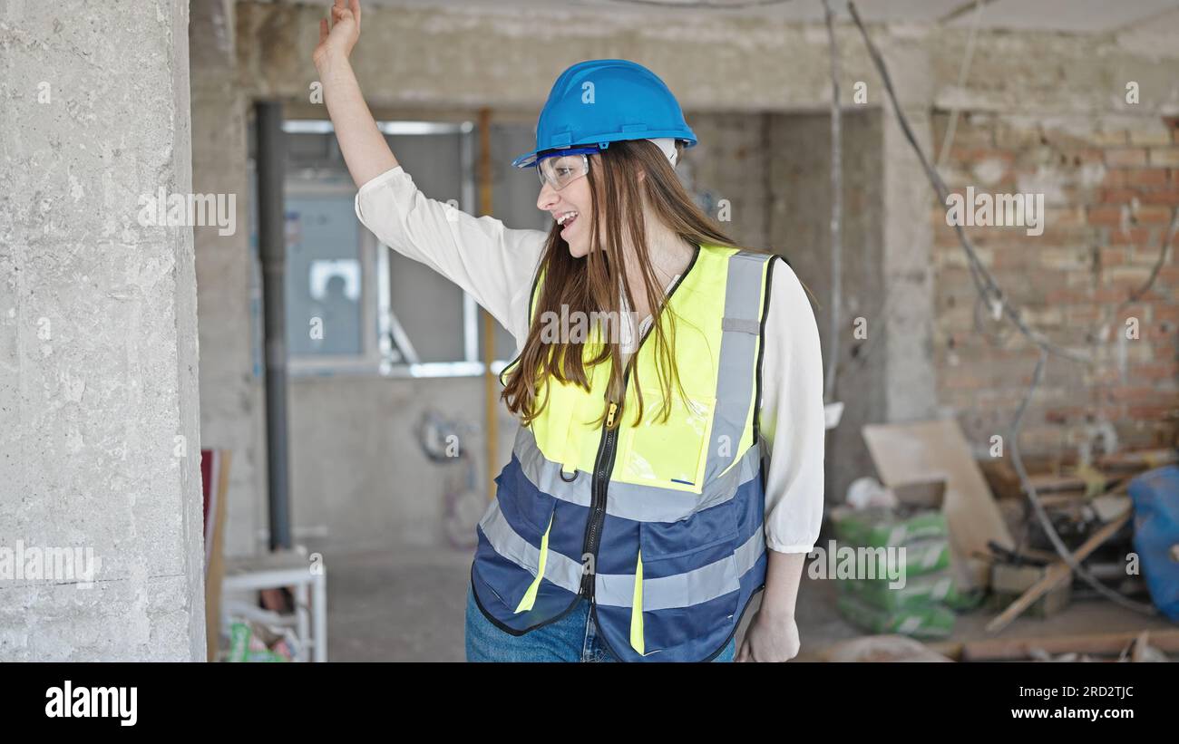 Young beautiful hispanic woman builder smiling confident dancing at ...