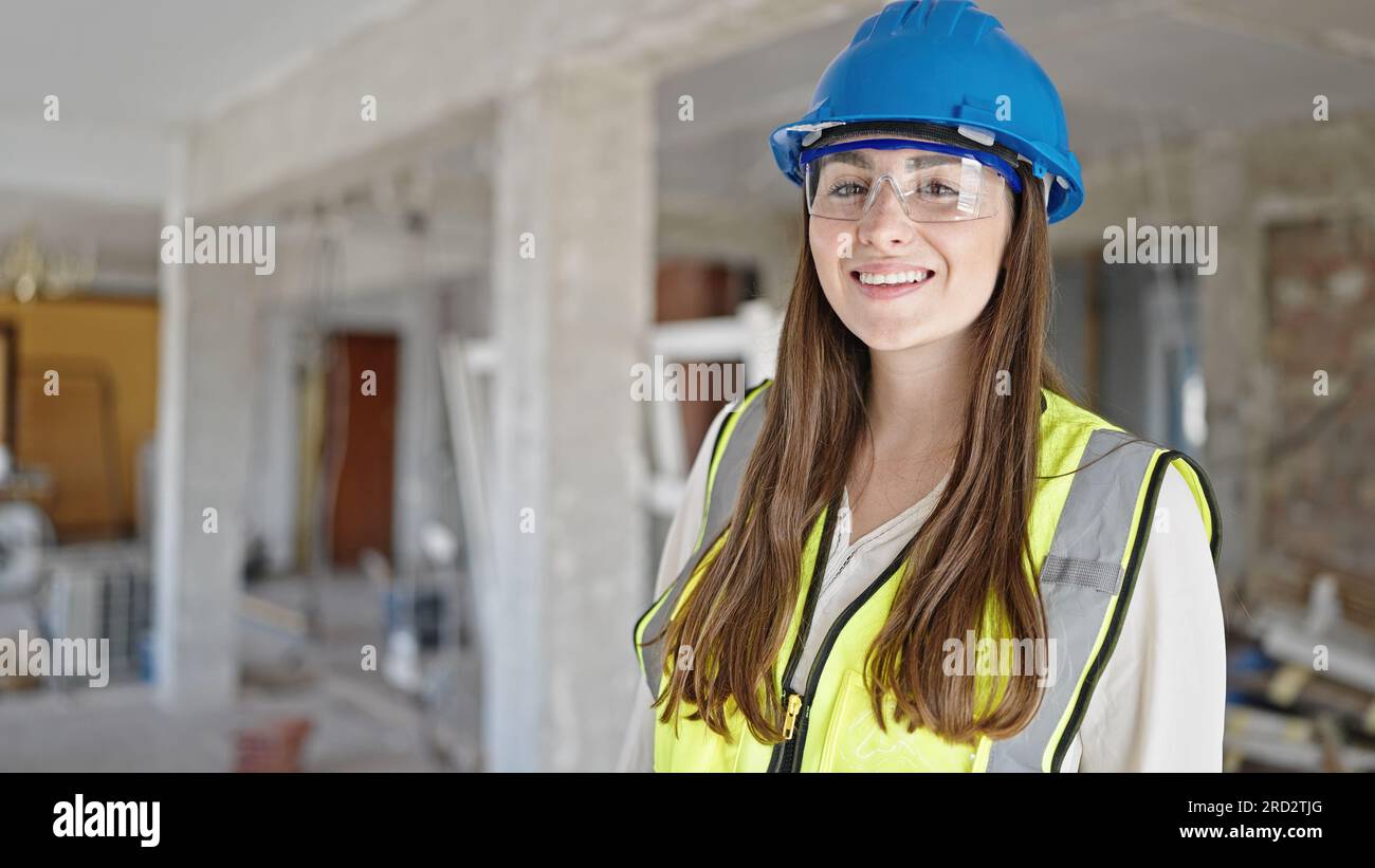 Young beautiful hispanic woman builder smiling confident standing at ...