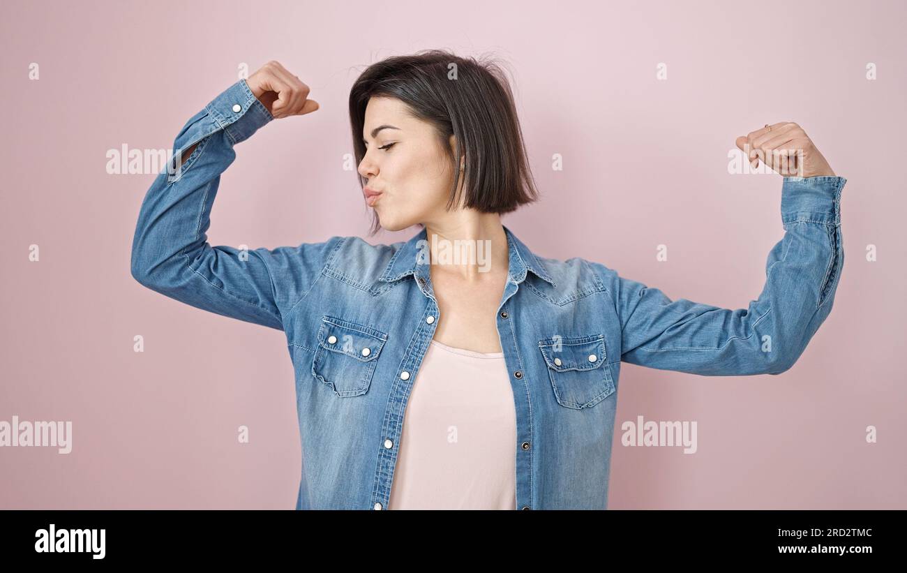 Young caucasian woman kissing arm doing strong gesture with arms over ...