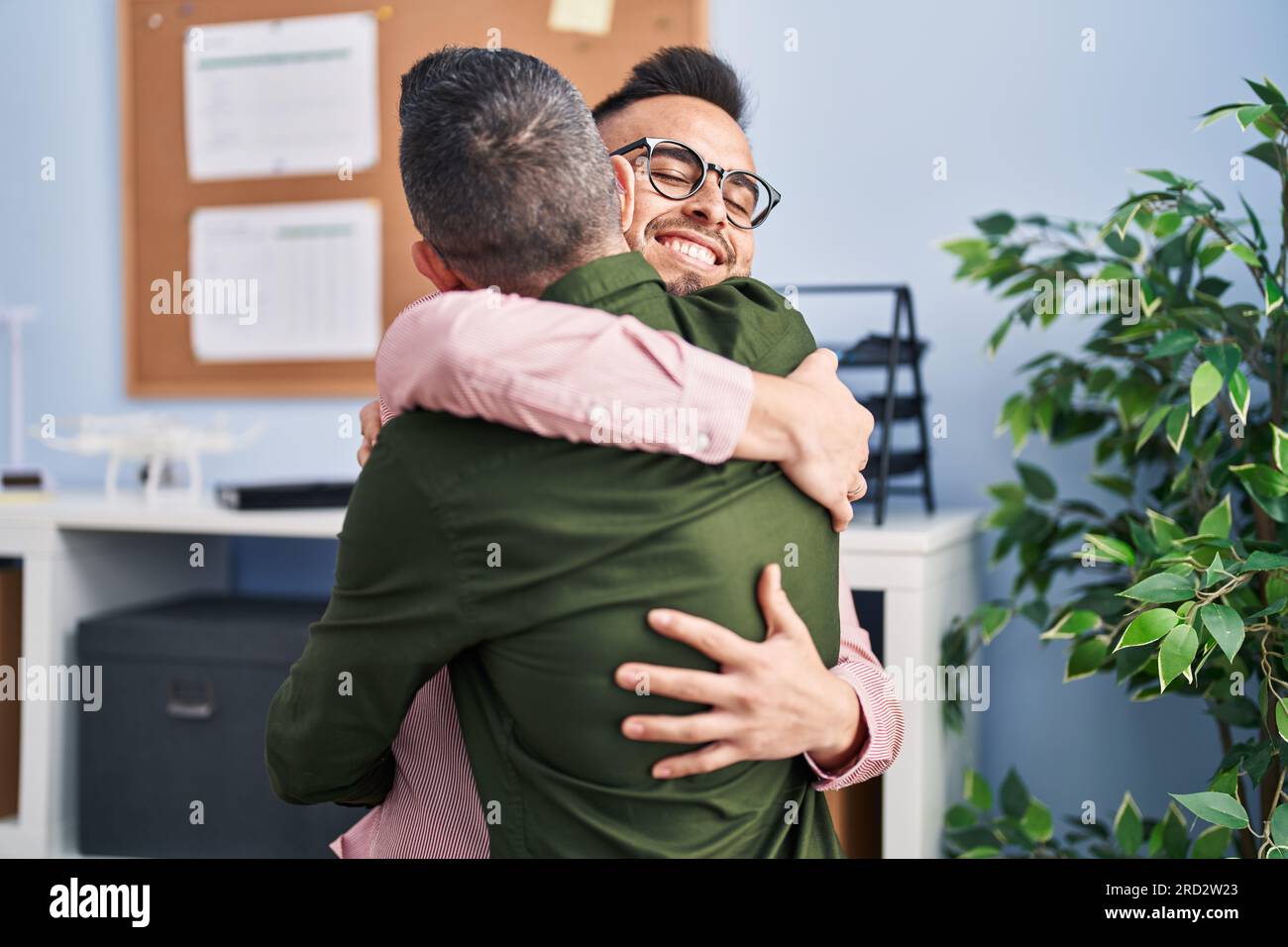 Two men business workers hugging each other at office Stock Photo - Alamy