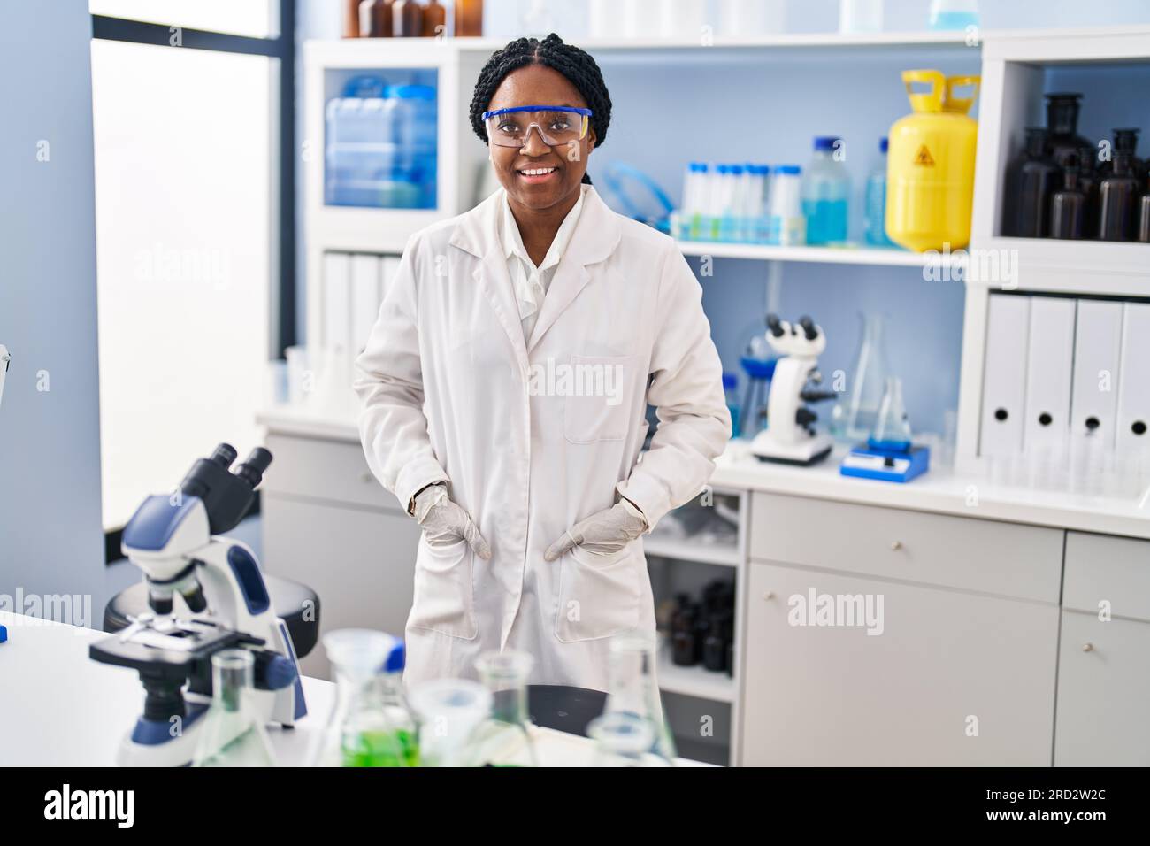 African american woman scientist smiling confident standing at laboratory Stock Photo - Alamy