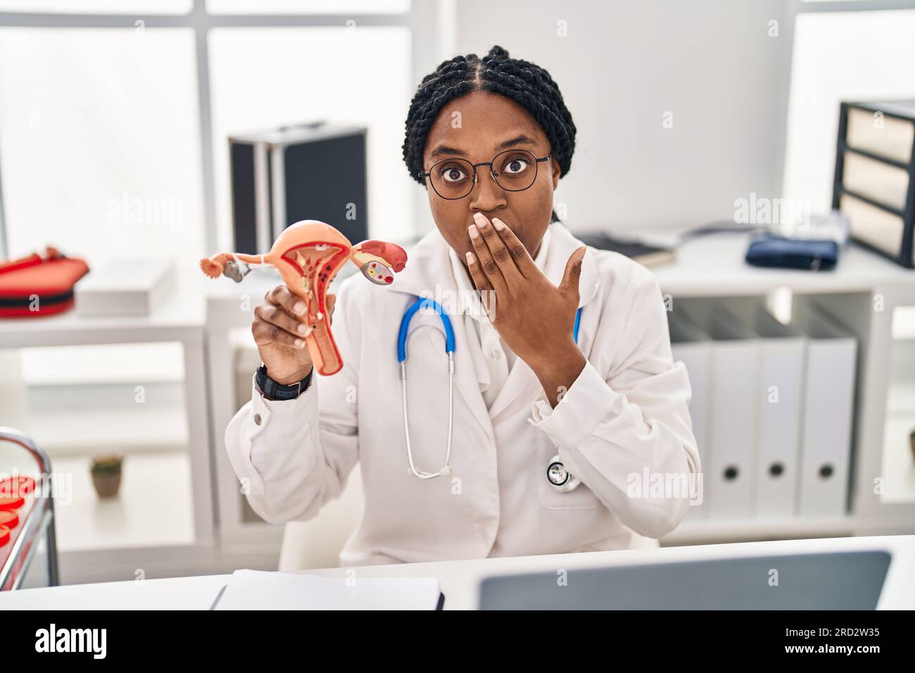 African american doctor woman holding anatomical model of female ...