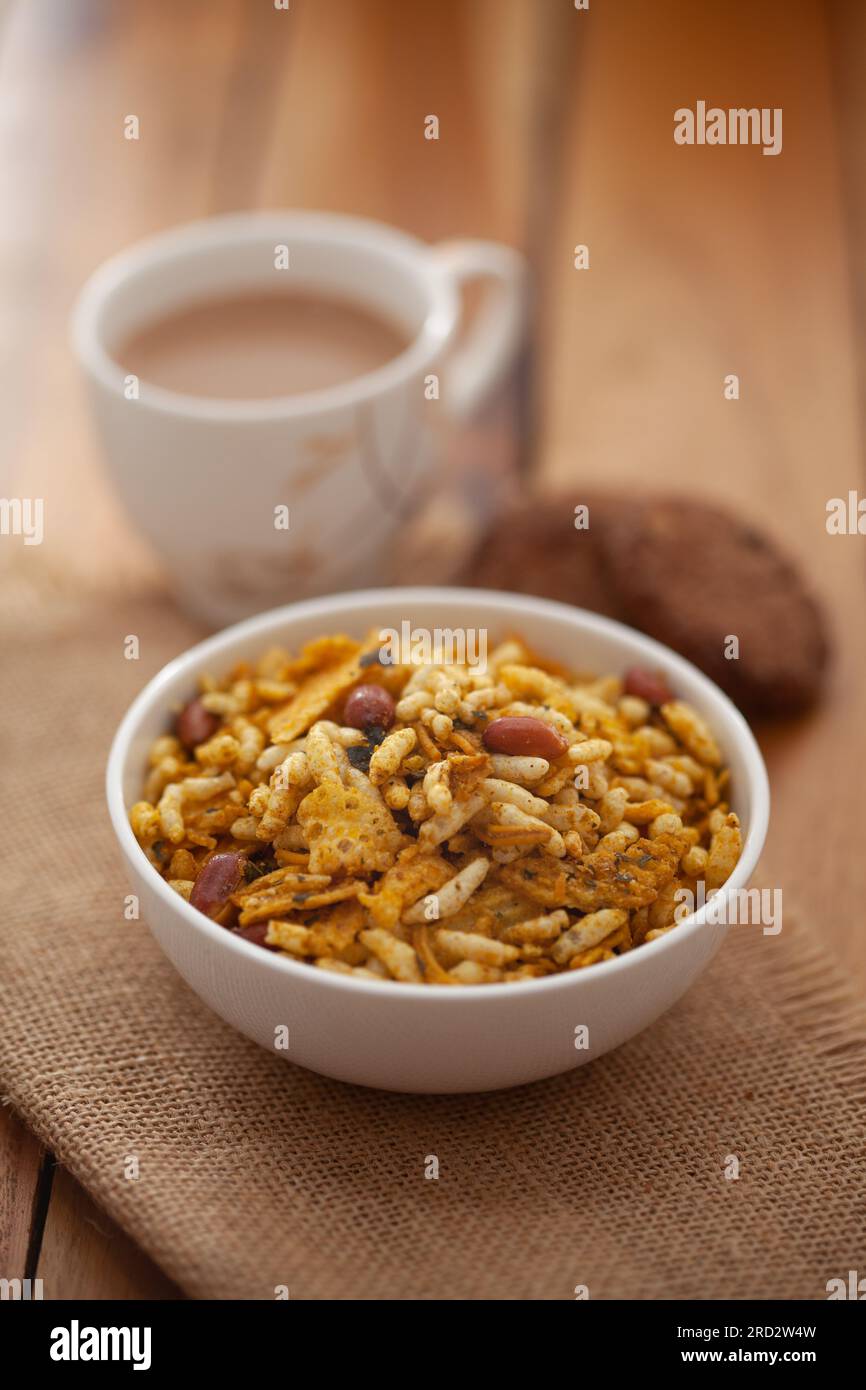 Close-Up of crunchy Indian mixture snacks with hot tea or Coffee time ...