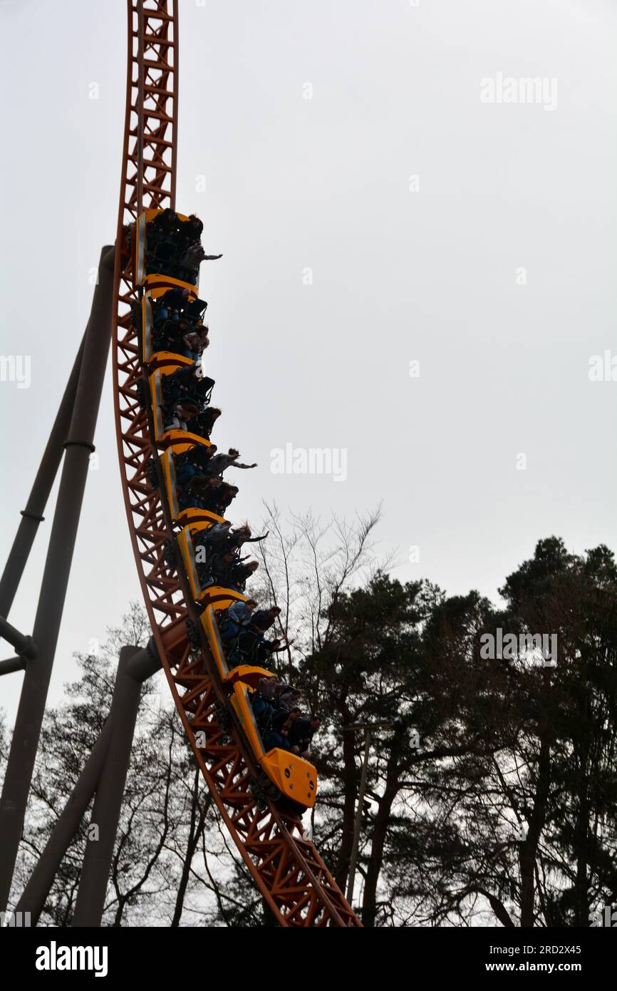 Steeply sloping Roller coaster with full carriages in the amusement ...