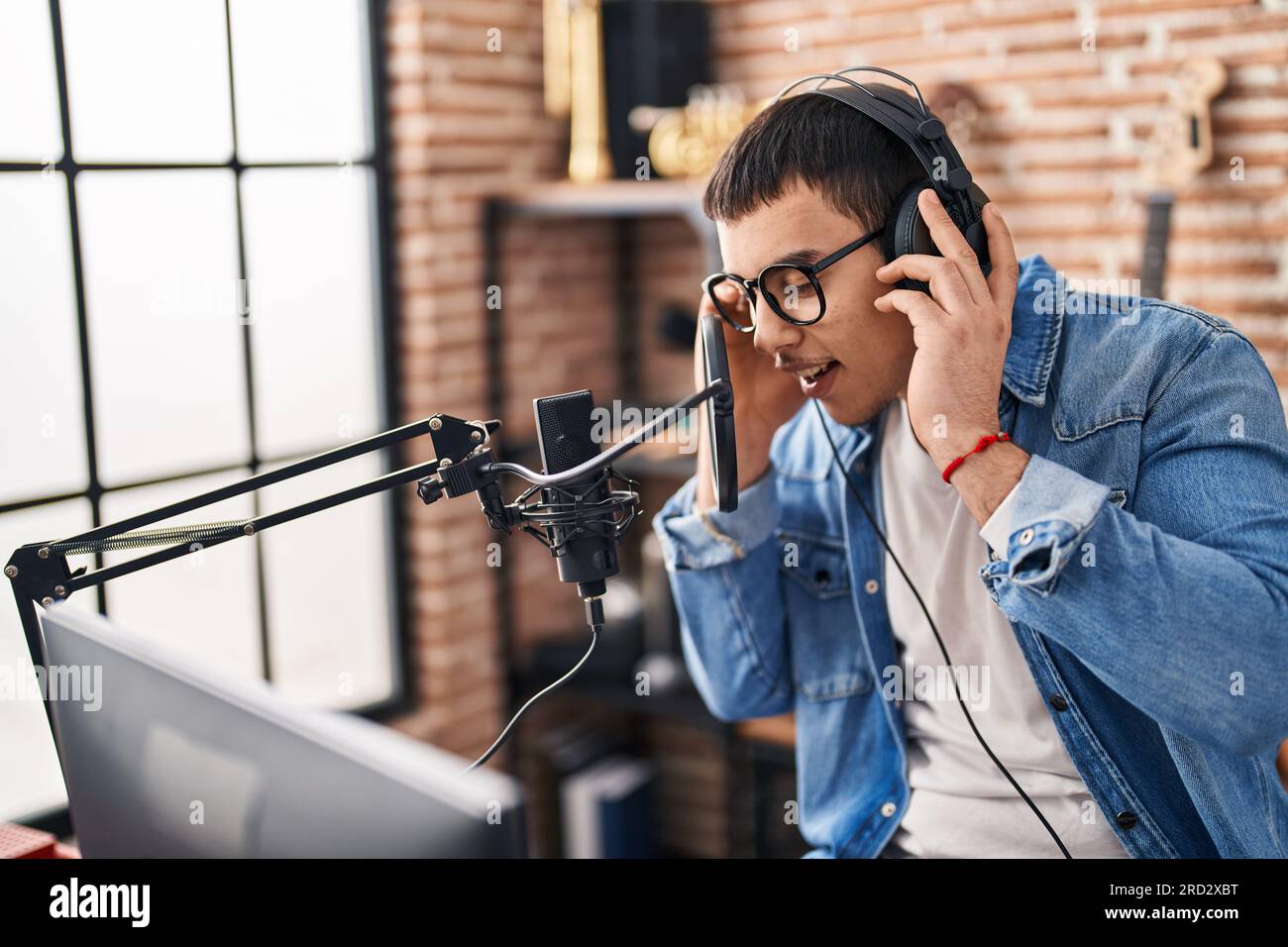 Young man artist singing song at music studio Stock Photo - Alamy