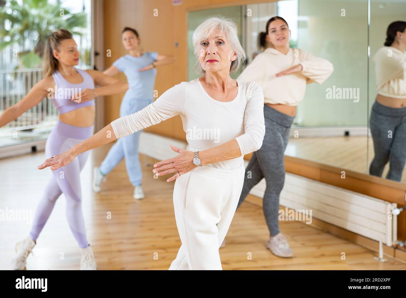 Group are practising arch movement in step jazz dance in fitness gym ...