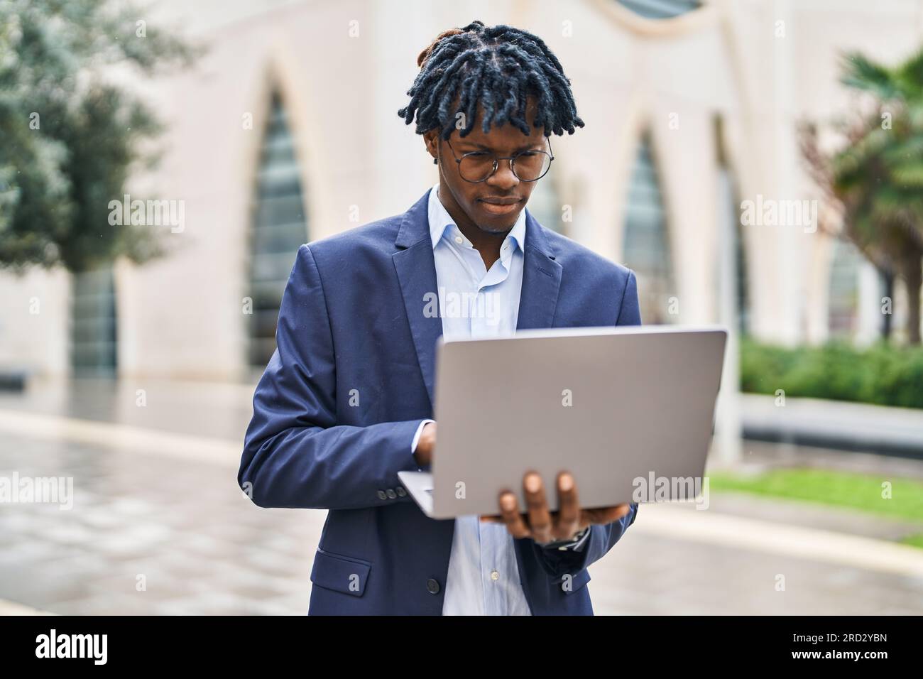 African american man executive using laptop at street Stock Photo - Alamy