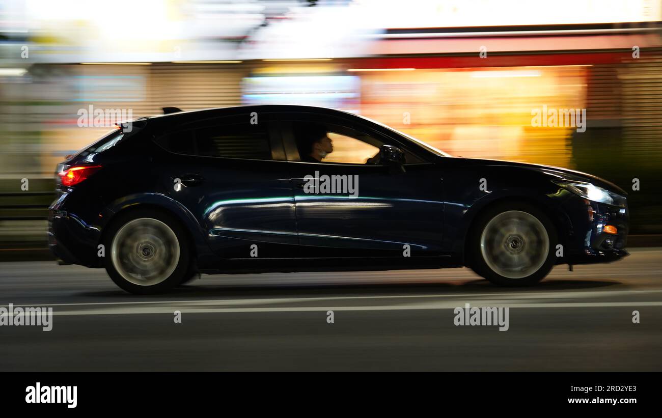 Fast Car in Tokyo at Night with Blurred Background Stock Photo - Alamy