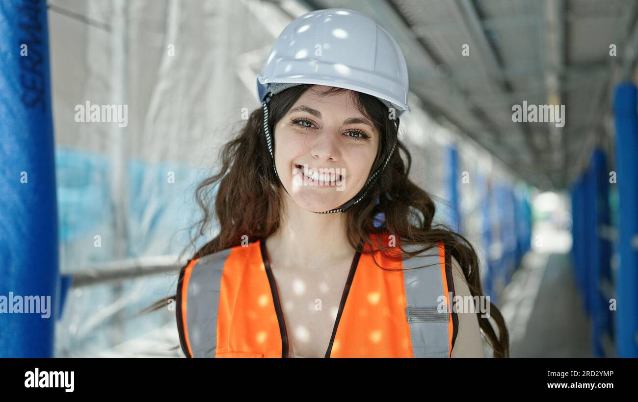 Young beautiful hispanic woman builder smiling confident standing at ...