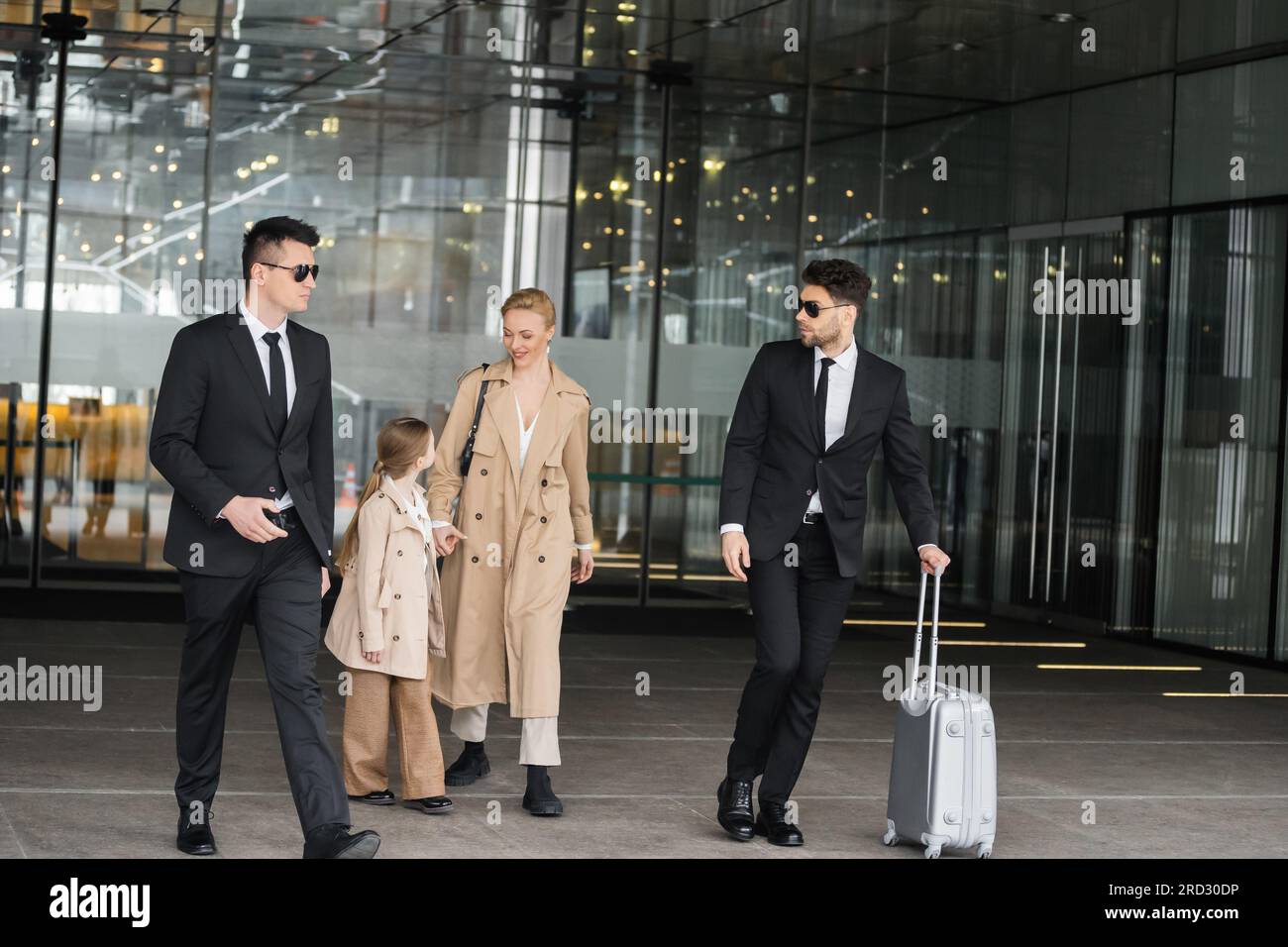 bodyguards protecting privacy of female clients, woman and girl walking ...