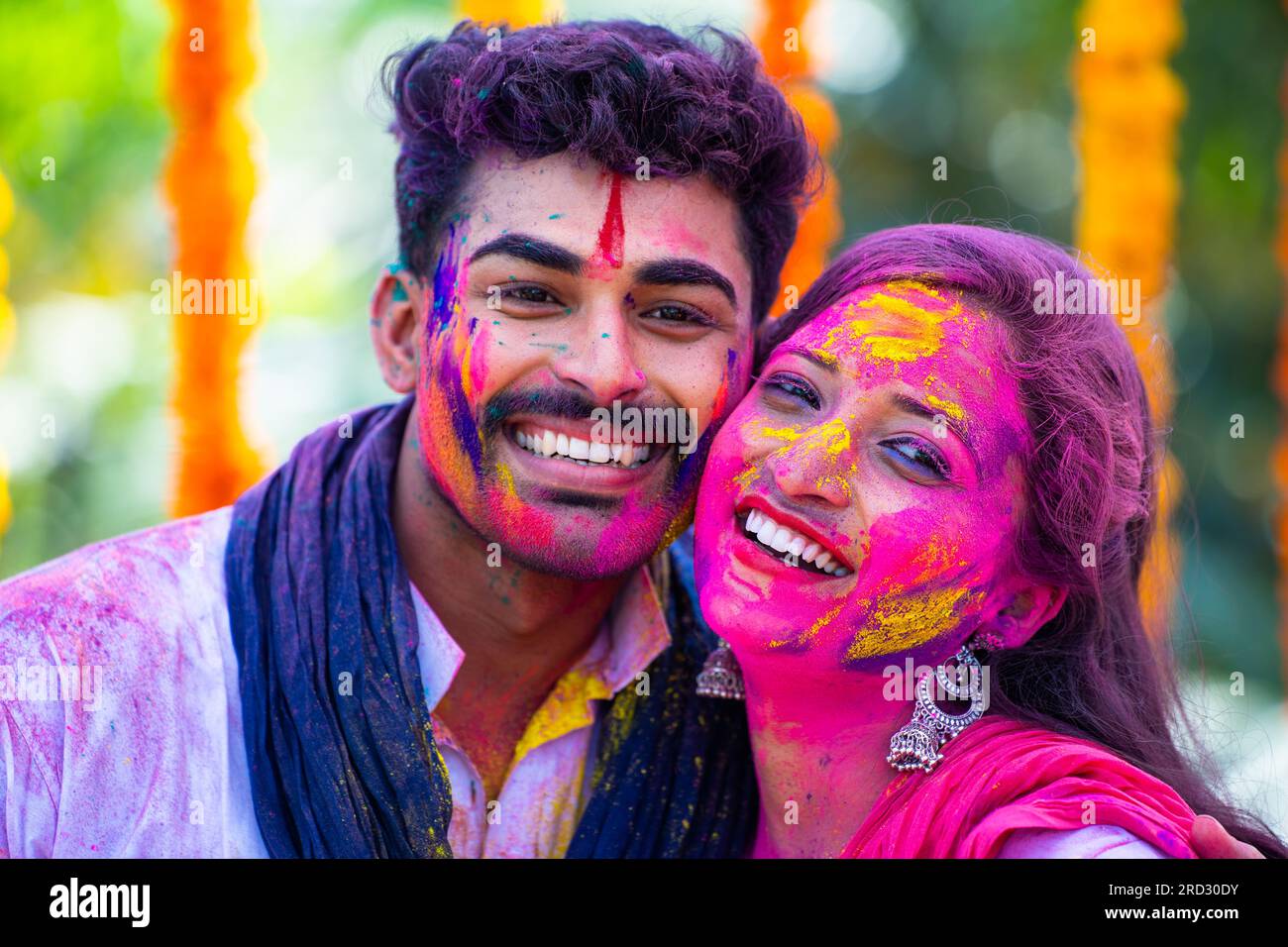 Close up shot of happy young indian couple with holi colour on face by ...