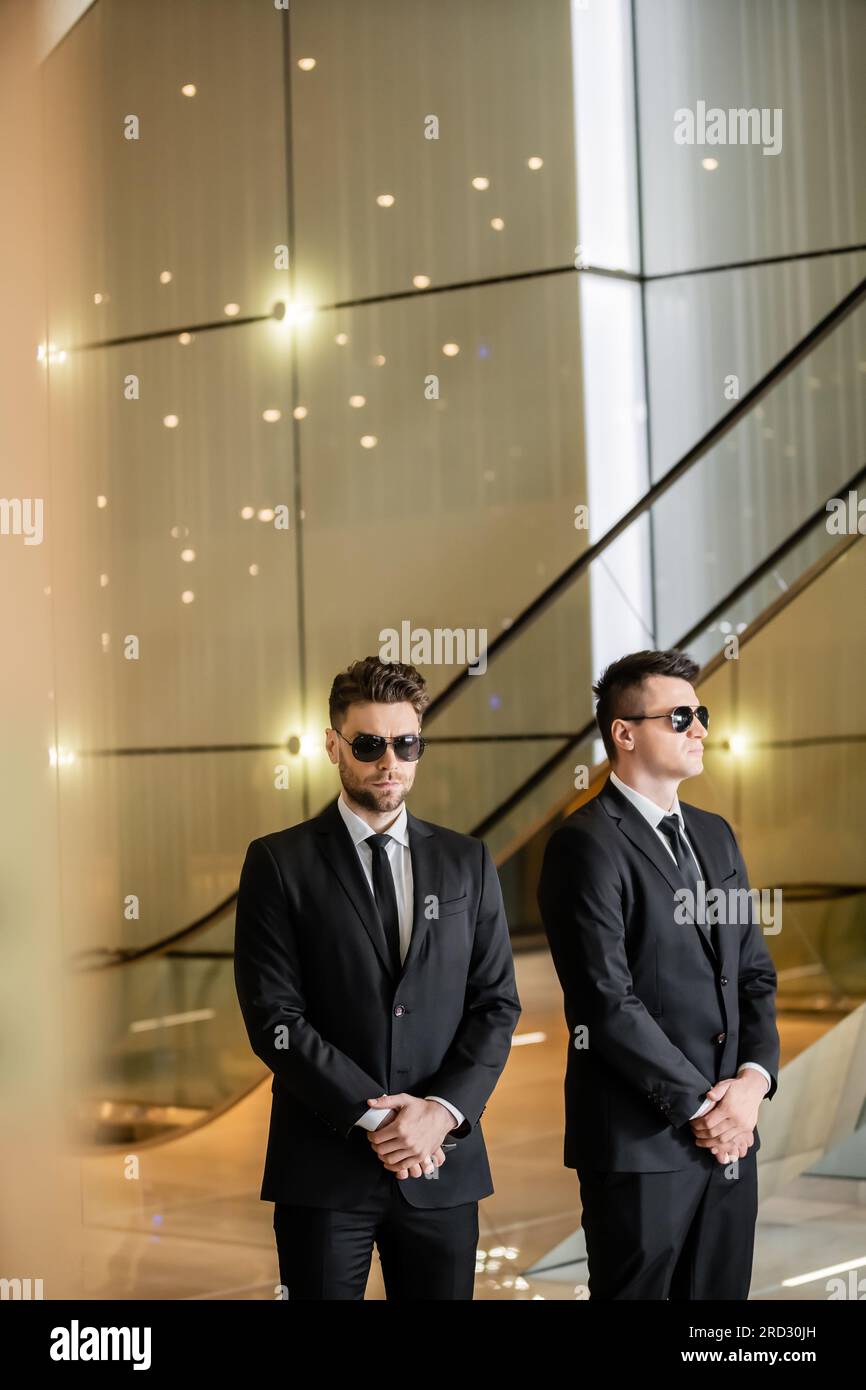 security management of hotel, two handsome men in formal wear and ...