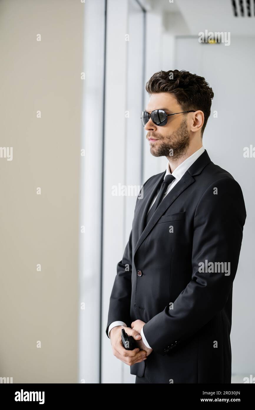 surveillance, bodyguard standing with walkie talkie, handsome security ...