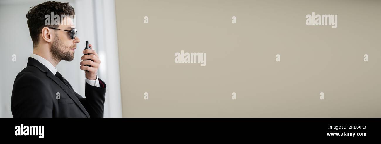 surveillance, bodyguard communicating through walkie talkie, man in ...